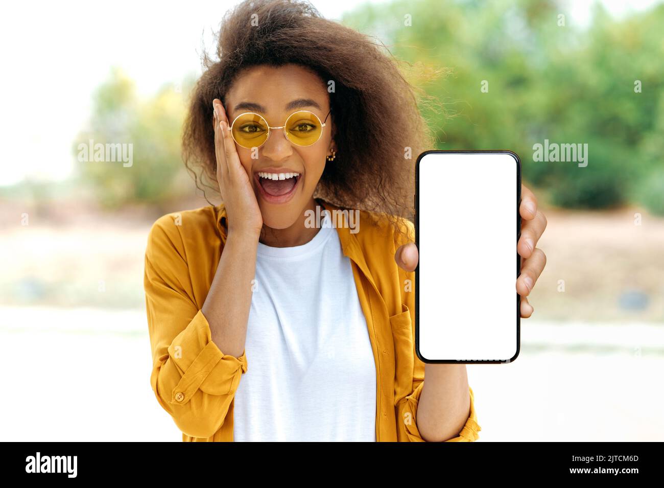 Mock-up. Photo of african american young woman with amazed facial ...