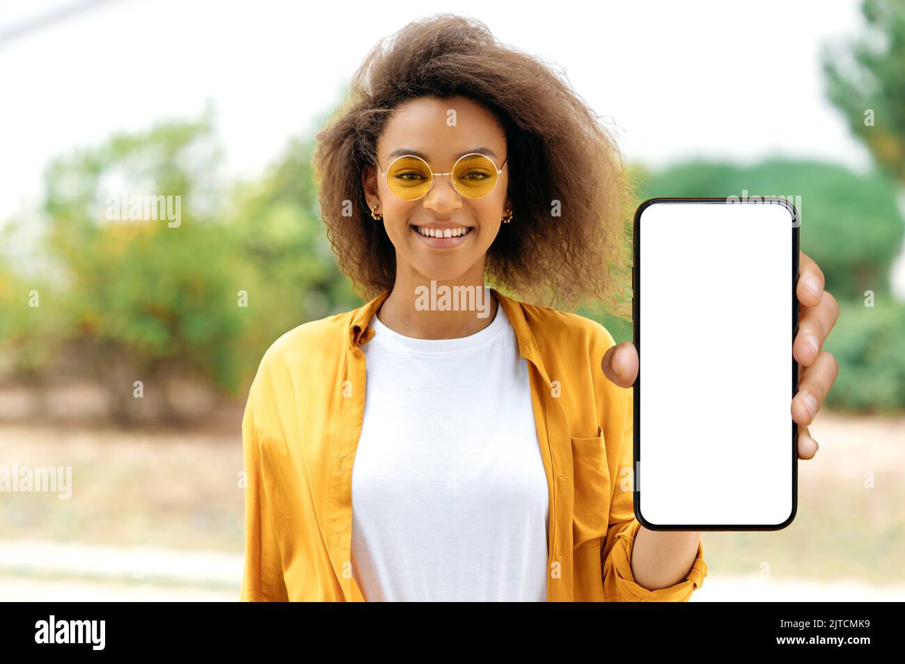 Positive african american curly young woman with happy facial ...