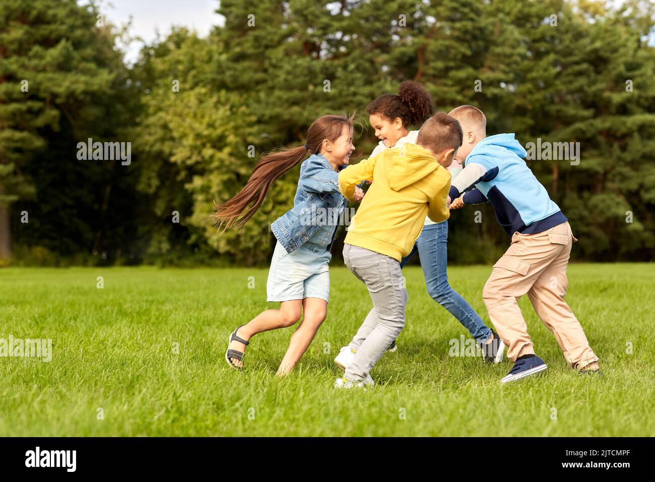 happy children playing round dance at park Stock Photo - Alamy