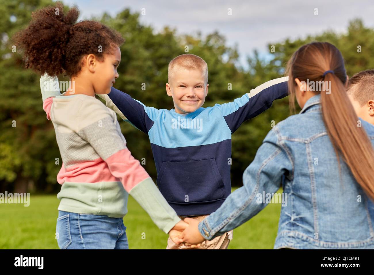 happy children playing round dance at park Stock Photo - Alamy