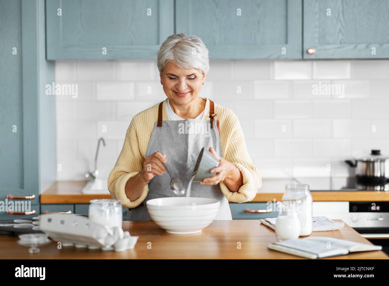 happy woman cooking food on kitchen at home Stock Photo - Alamy