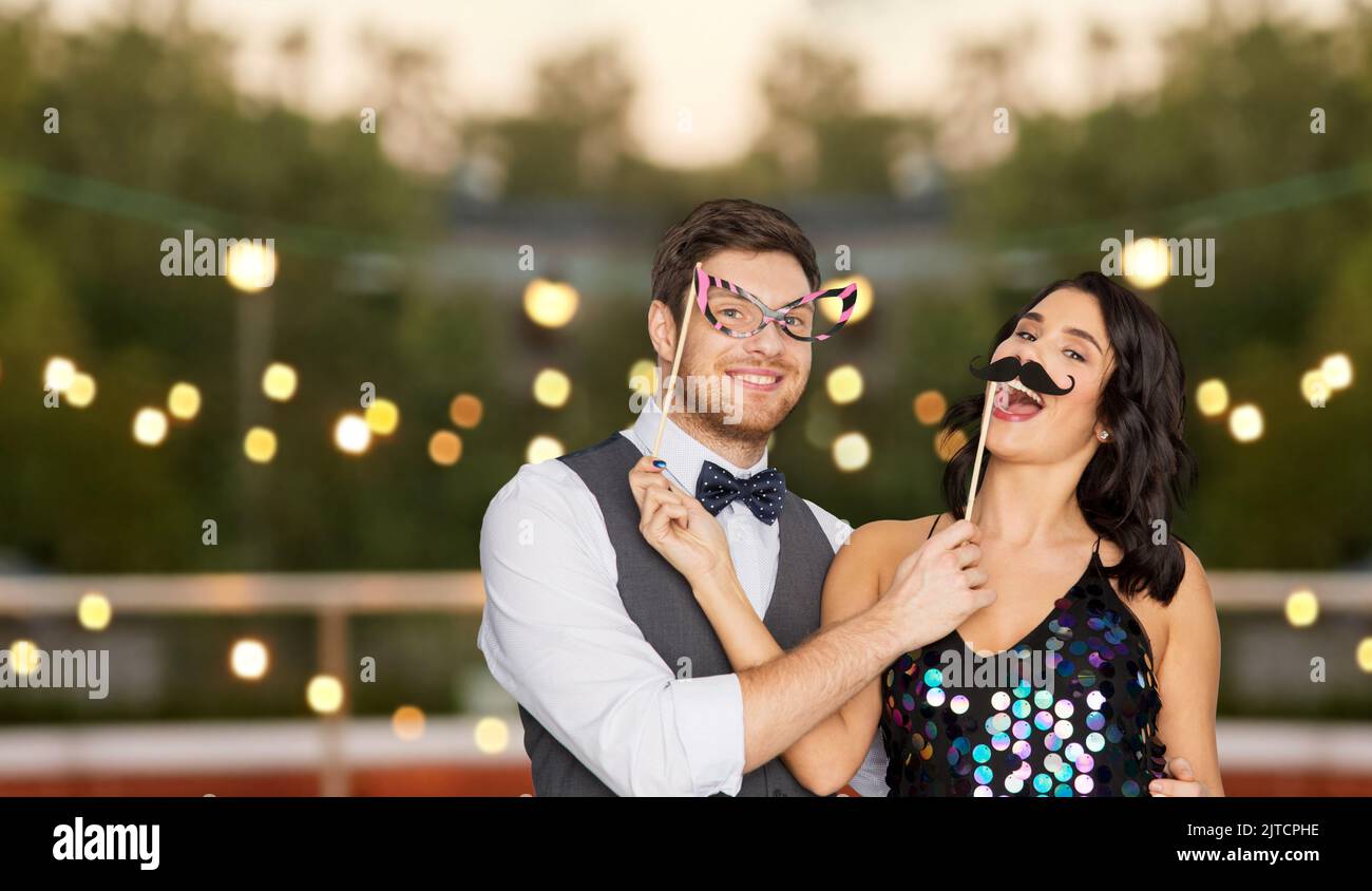 happy couple with party props having fun Stock Photo - Alamy