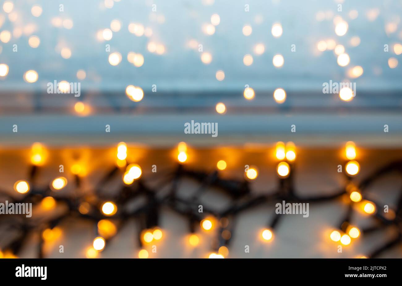 blurred electric garland lights on window sill Stock Photo - Alamy