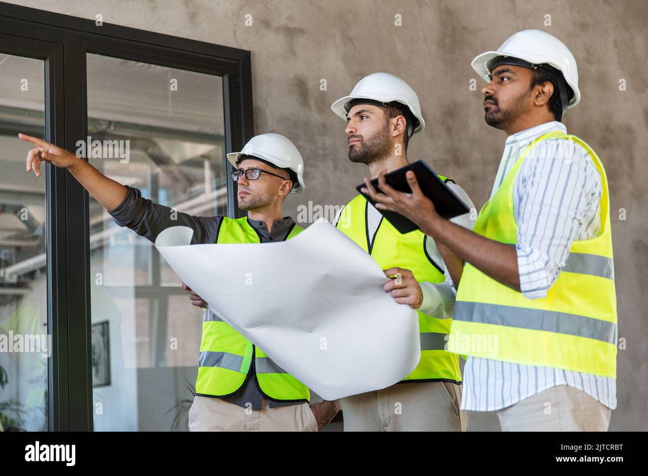architects with blueprint in office building Stock Photo - Alamy