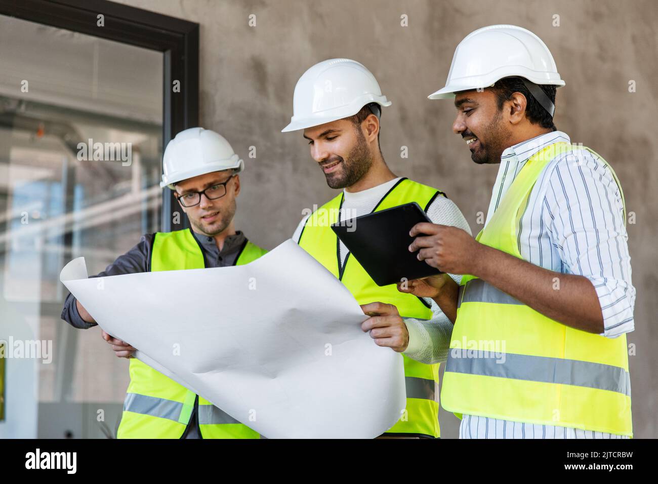 architects with blueprint in office building Stock Photo - Alamy