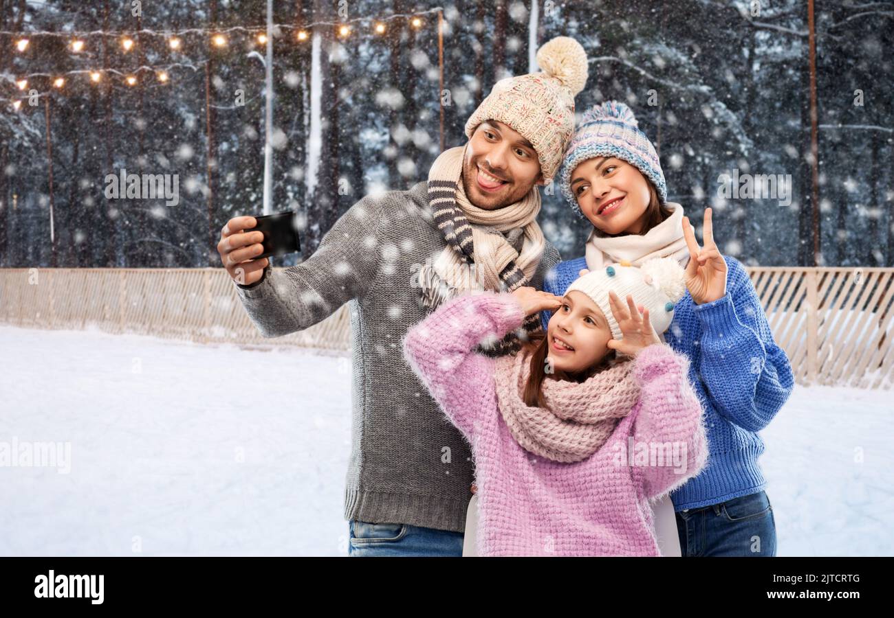 family taking selfie with smartphone at ice rink Stock Photo - Alamy