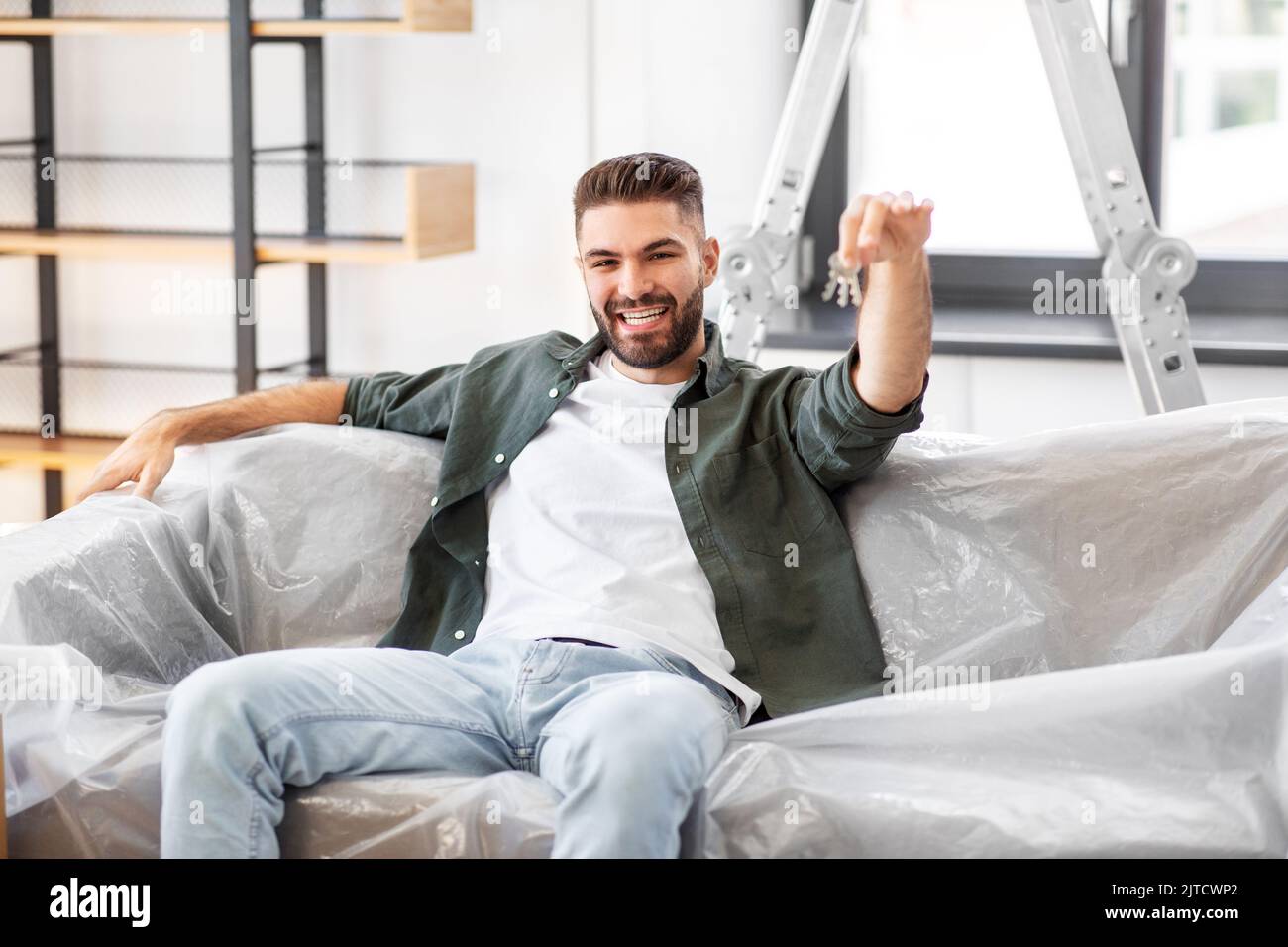 man with house keys and boxes moving to new home Stock Photo - Alamy