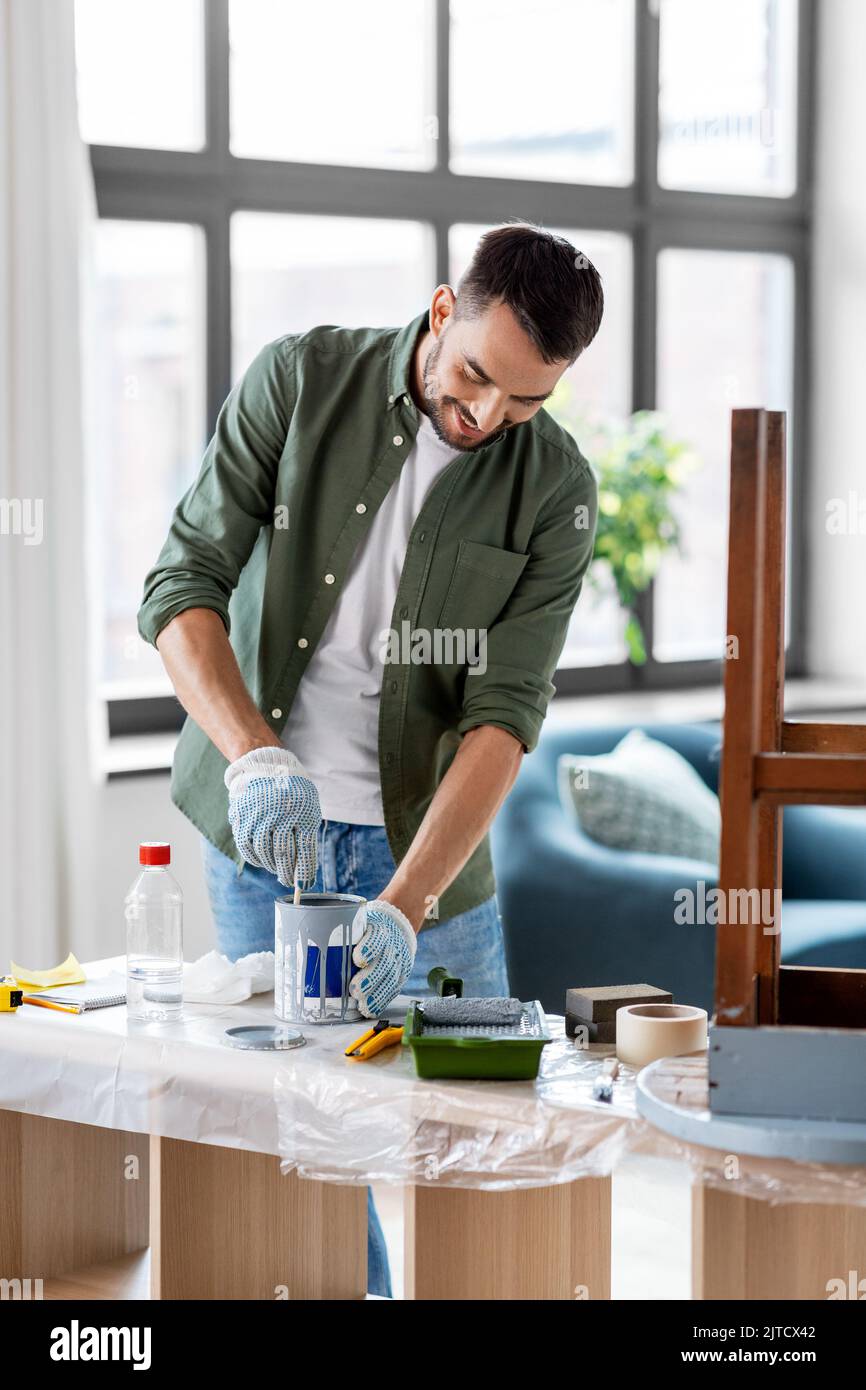 man stirring can with grey color paint at home Stock Photo - Alamy