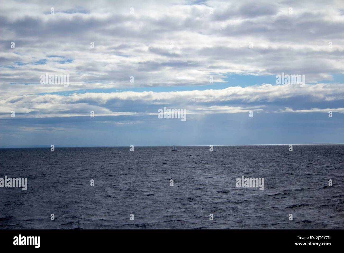 A boat drifting across the ocean Stock Photo - Alamy