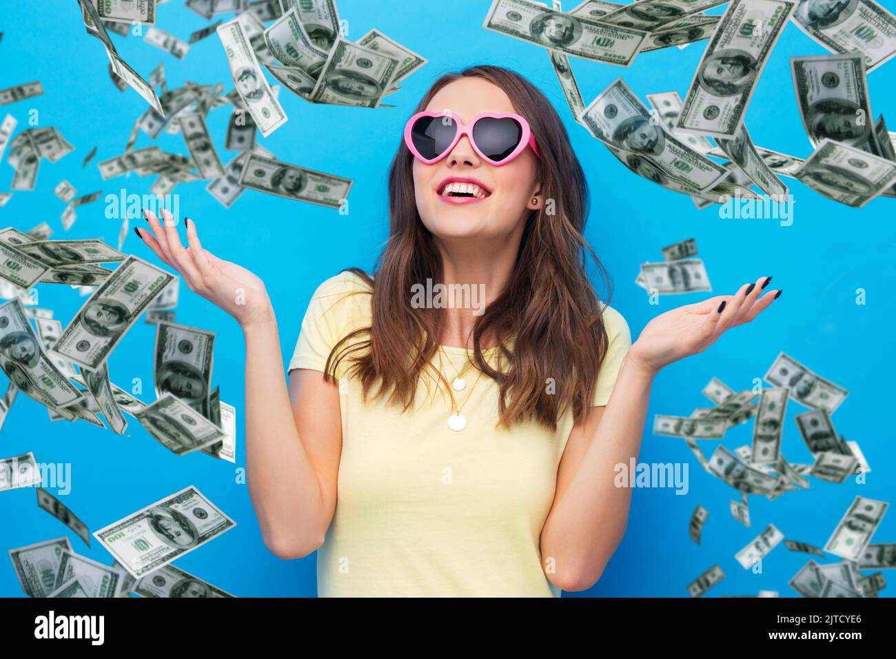 teenage girl in heart-shaped sunglasses over money Stock Photo - Alamy