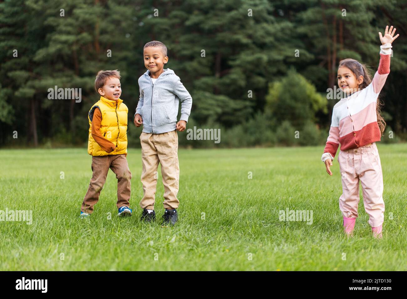 happy children playing and jumping at park Stock Photo - Alamy