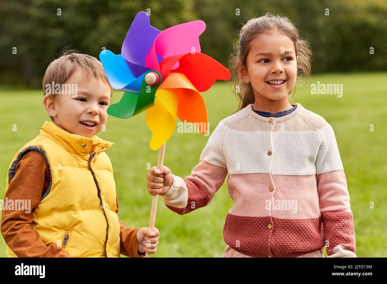 happy kids with pinwheel having fun at park Stock Photo - Alamy