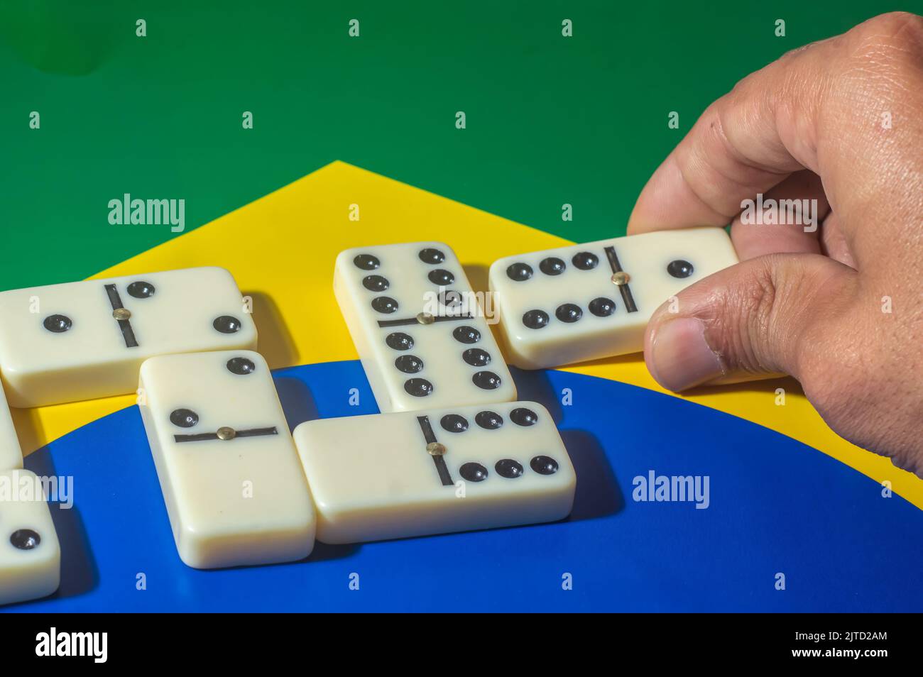 Domino game on top of a yellow and blue green flag,Brazilian colors ...