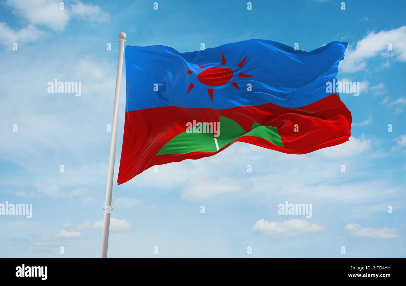 flag of Austroasiatic peoples Wa people at cloudy sky background ...