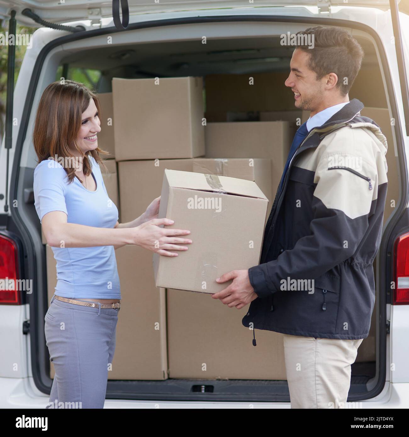 Hes Committed To Great Customer Service A Delivery Man Making A Delivery To A Customer At Her