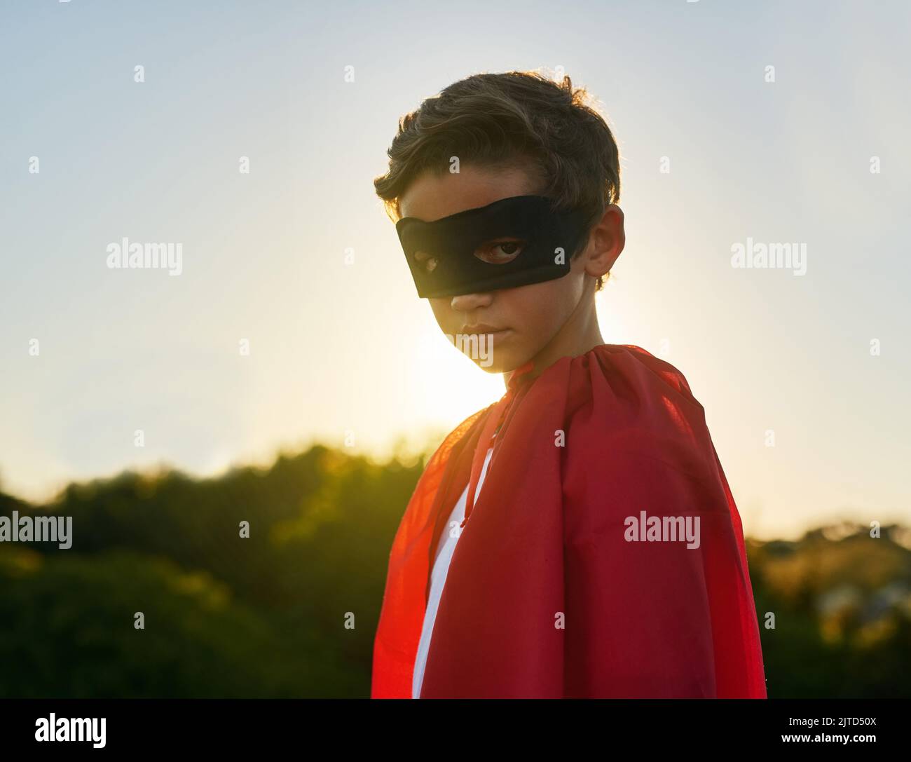 villain better watch out. Portrait of a young boy in a cape and mask ...