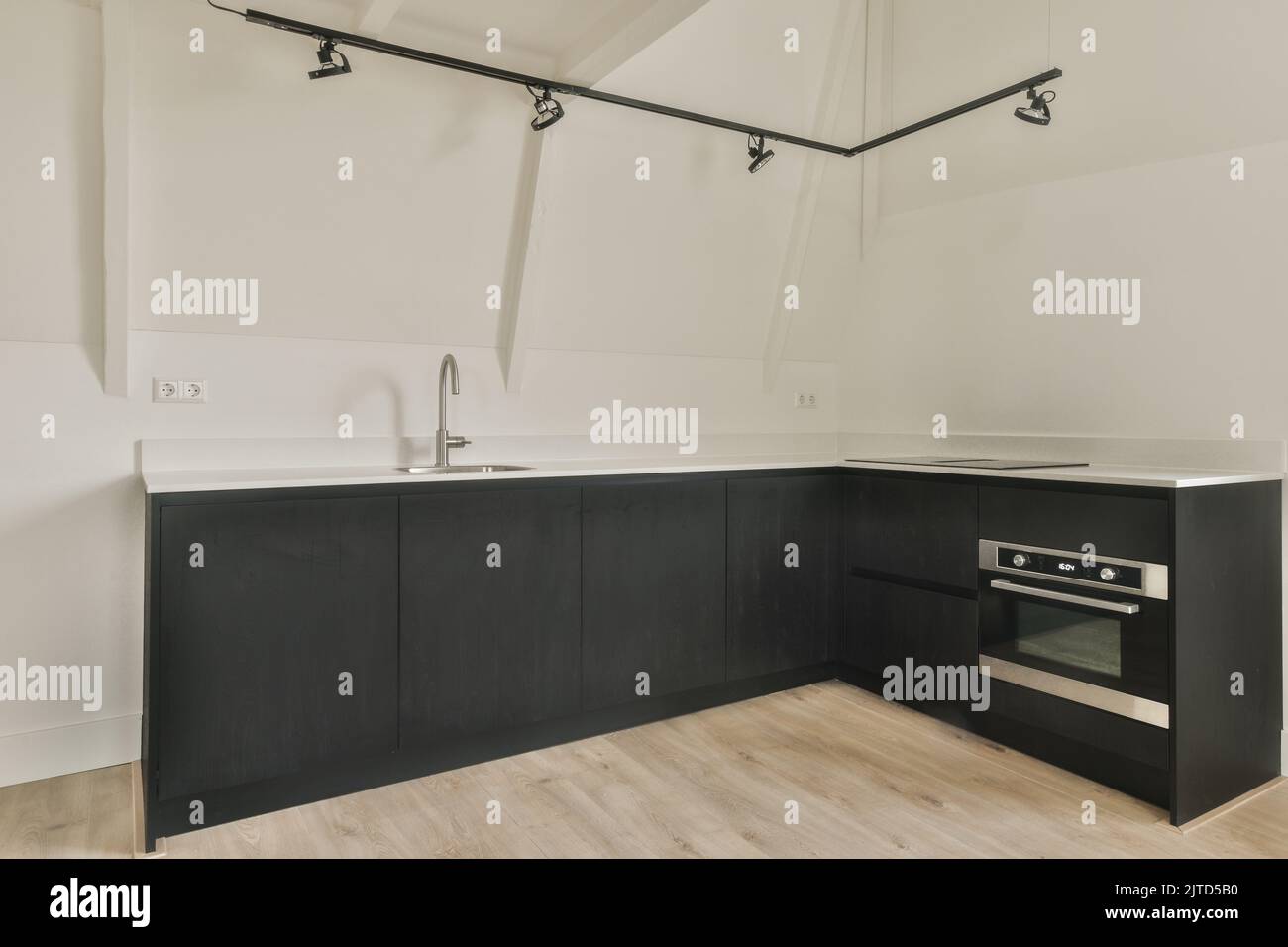 Interior of empty white kitchen with corridor and wooden parquet floor ...