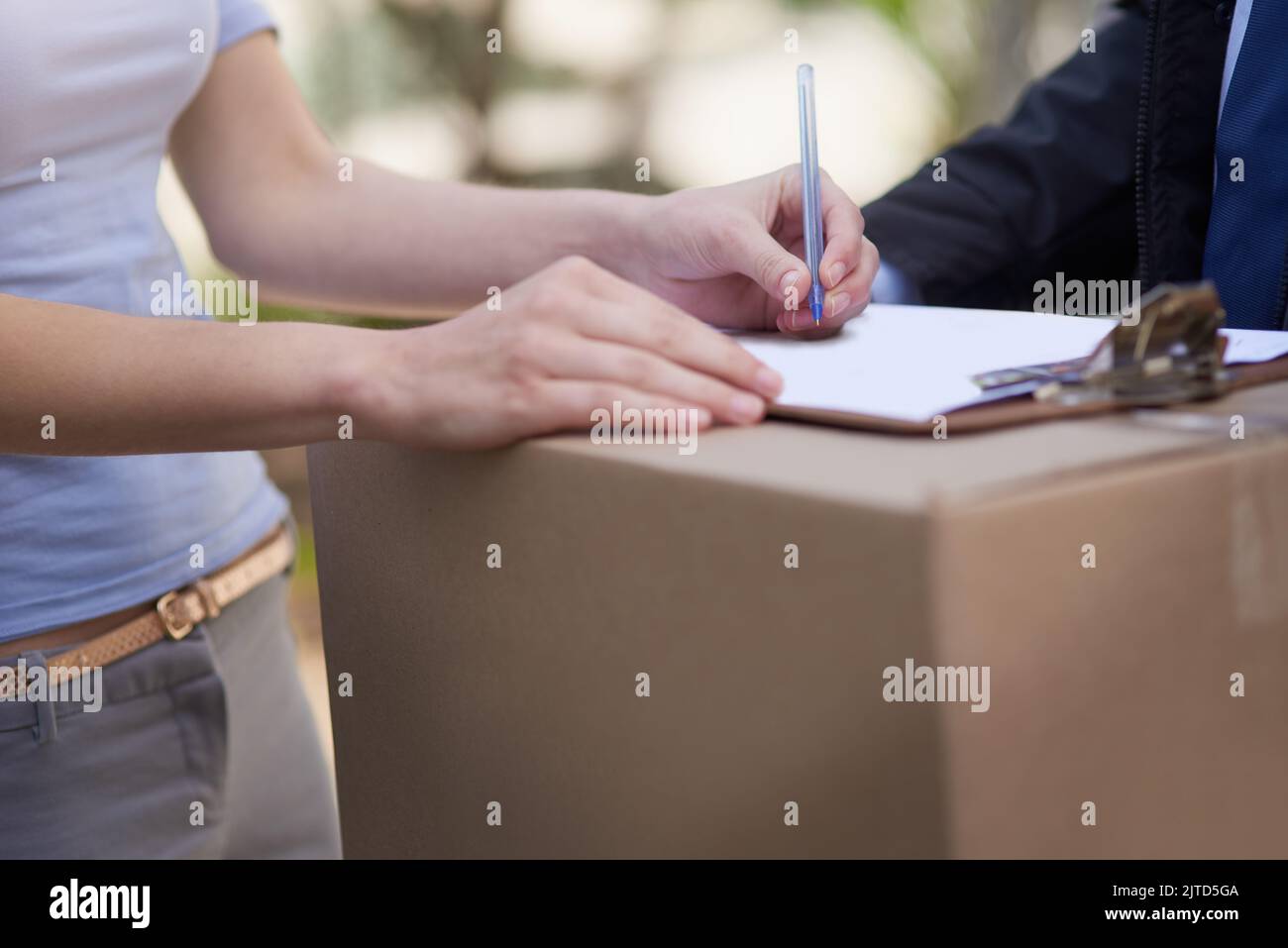 Sign here please...an unidentifiable woman signing for the delivery of ...