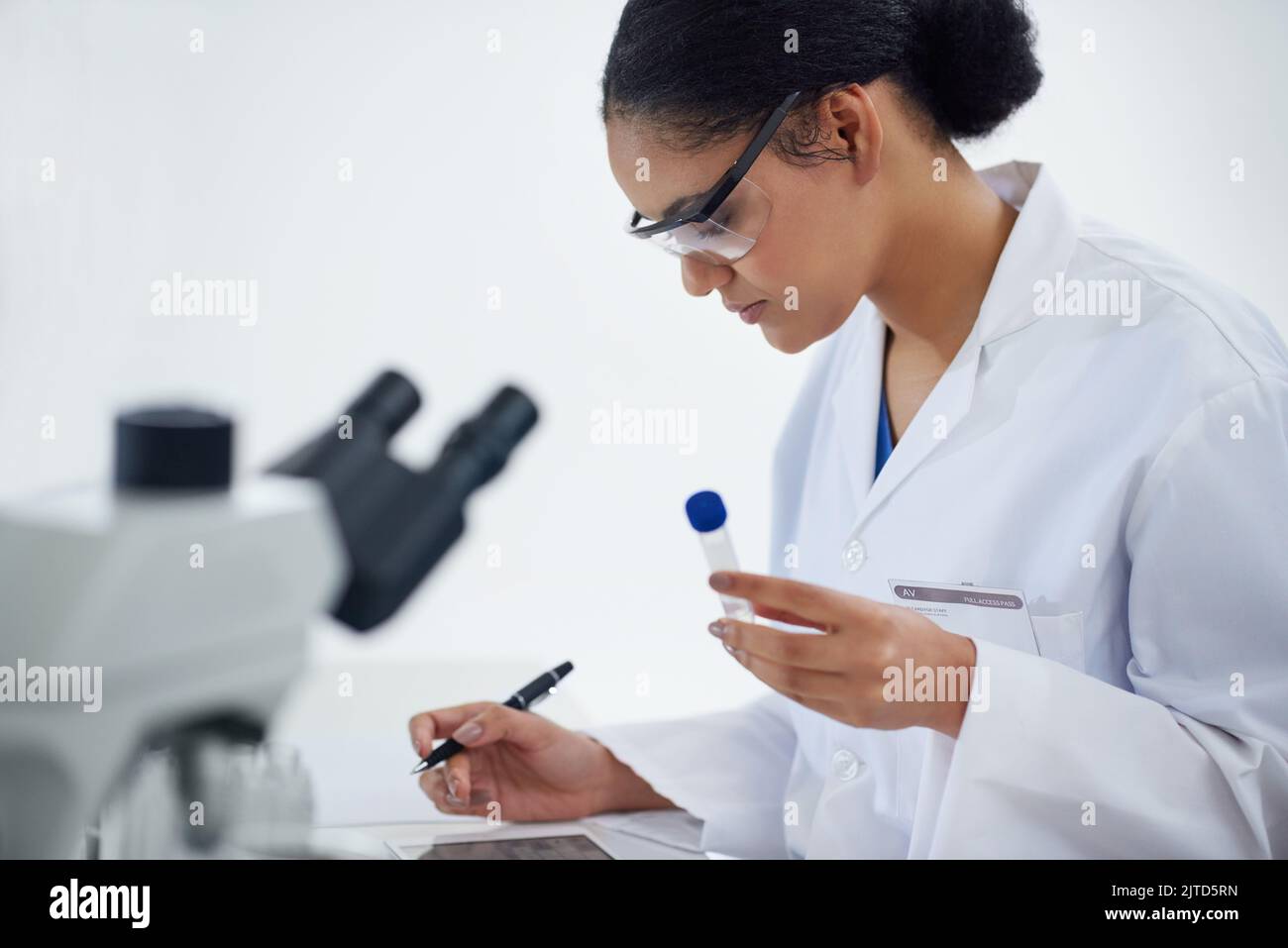 Analysing the sample. an attractive young female scientist working in ...