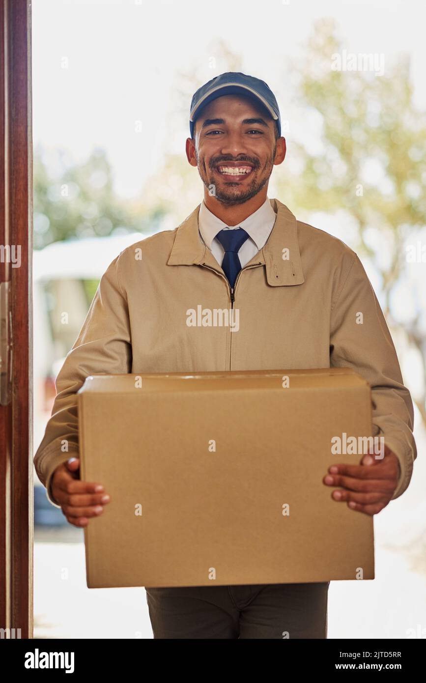 Your package has arrived. Portrait of a friendly delivery man ...