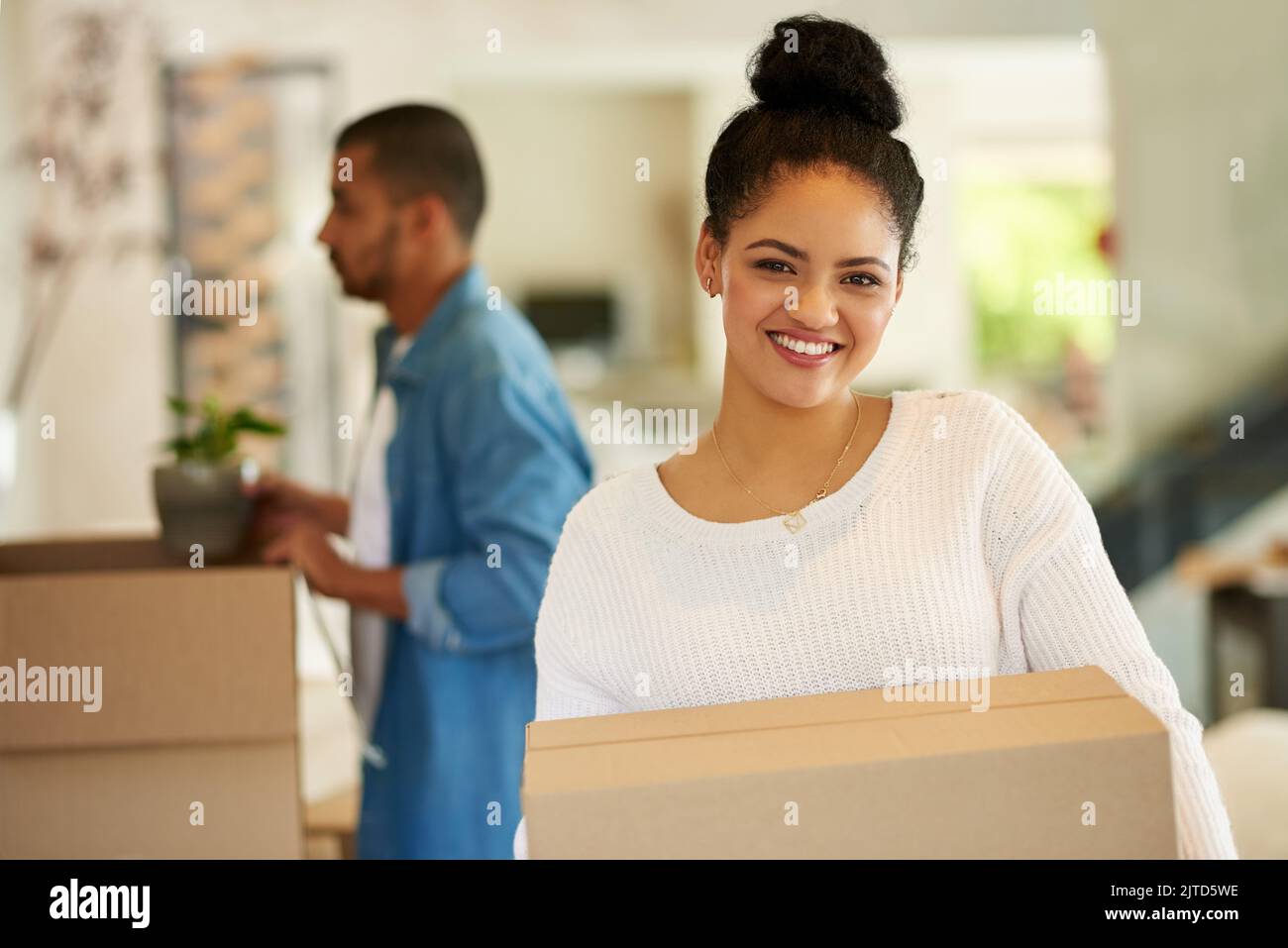 This move is another milestone on our journey. a happy young woman ...