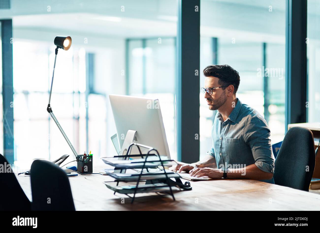 True success comes from doing. a focused young businessman using a ...