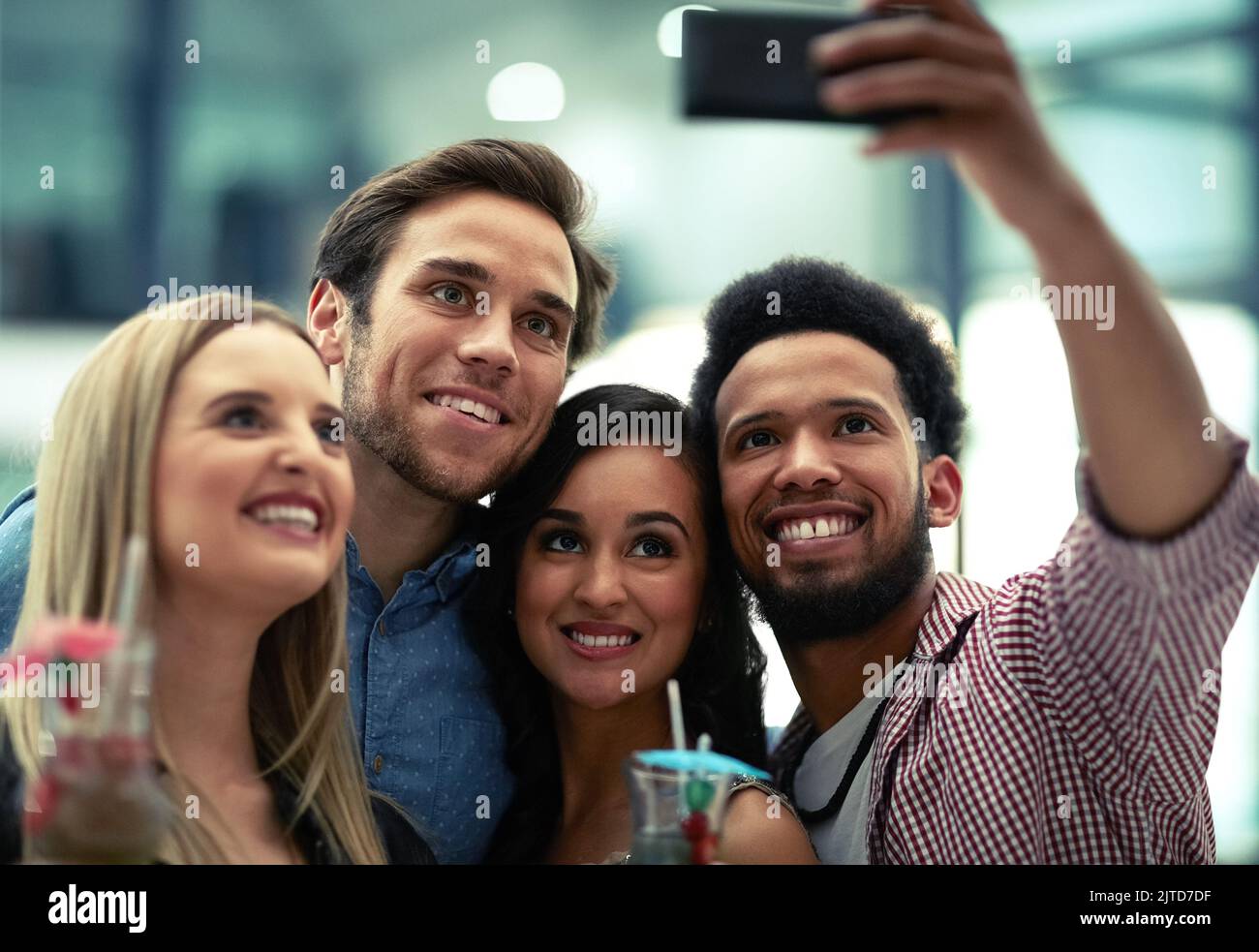 Anytime is selfie time. a happy group of friends taking a selfie with a ...