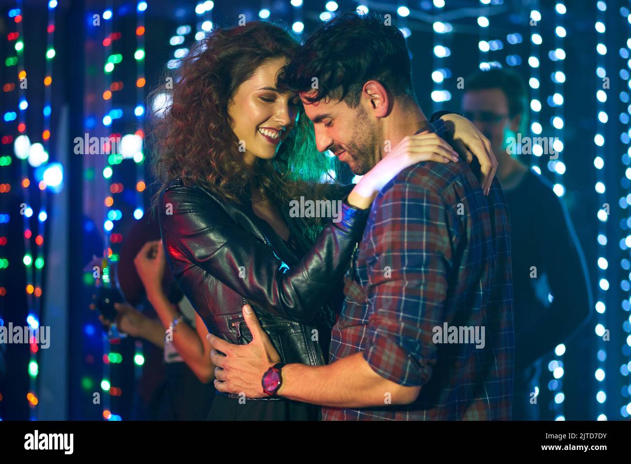 We love the nightlife. an affectionate young couple dancing together in a nightclub Stock Photo ...