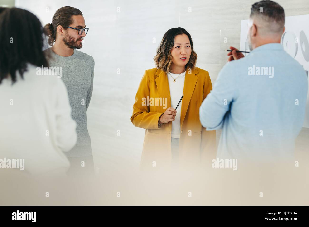 Diverse design professionals sharing innovative ideas during a meeting ...