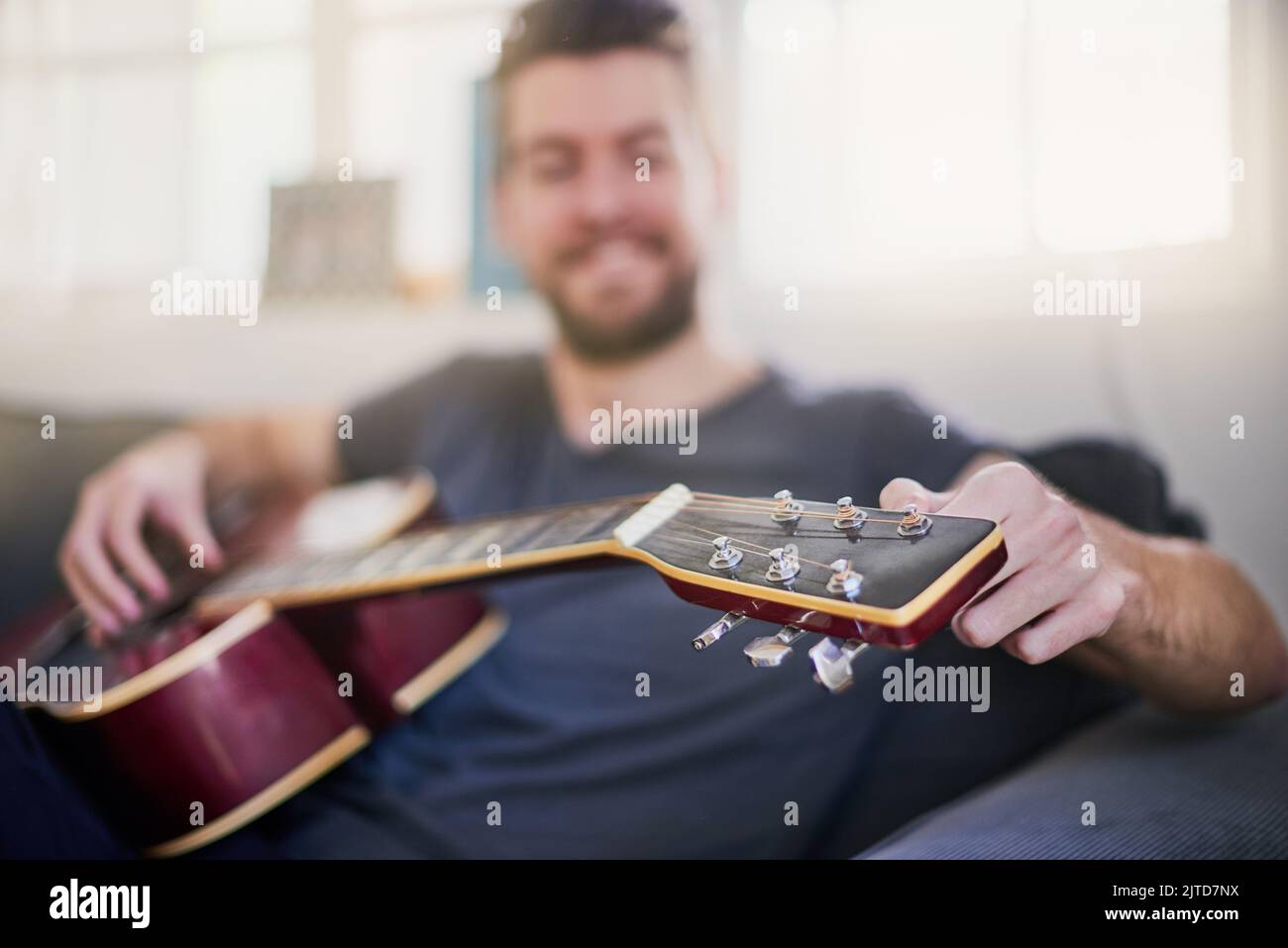 Young guy playing guitar home hi-res stock photography and images - Alamy