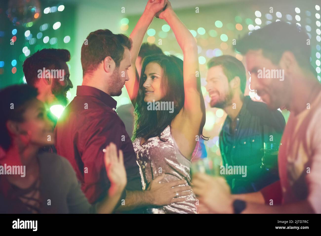 Telling him all with her eyes. an affectionate young couple dancing on ...