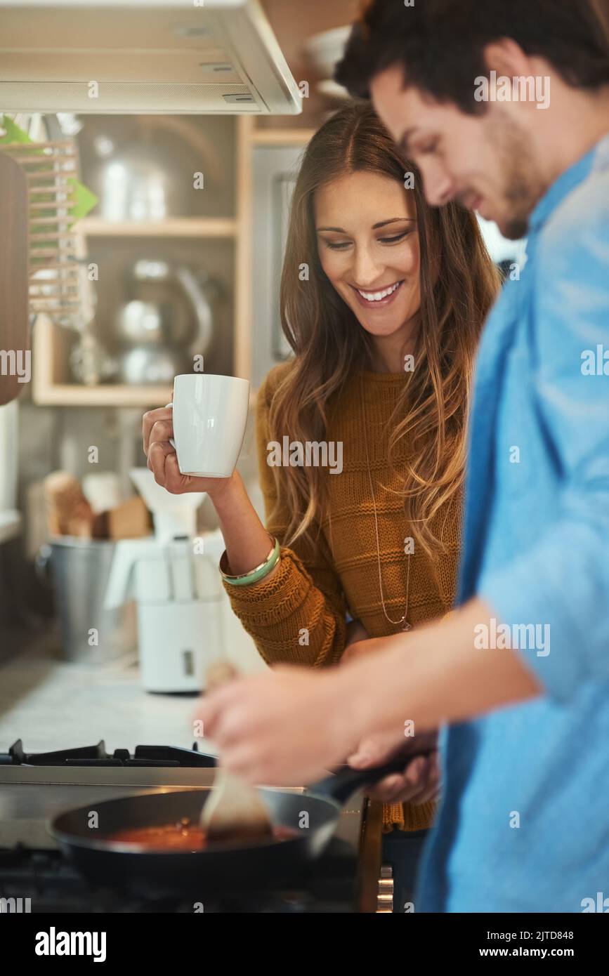 She loves watching him cook. an attractive young woman watching her ...