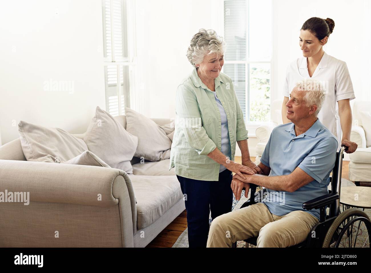 There to give him a helping hand. a smiling caregiver with a senior man ...