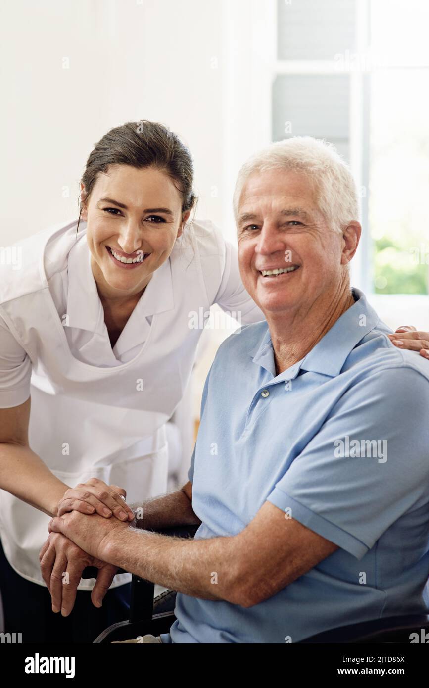 She keeps him healthy and smiling. Portrait of a smiling caregiver and ...