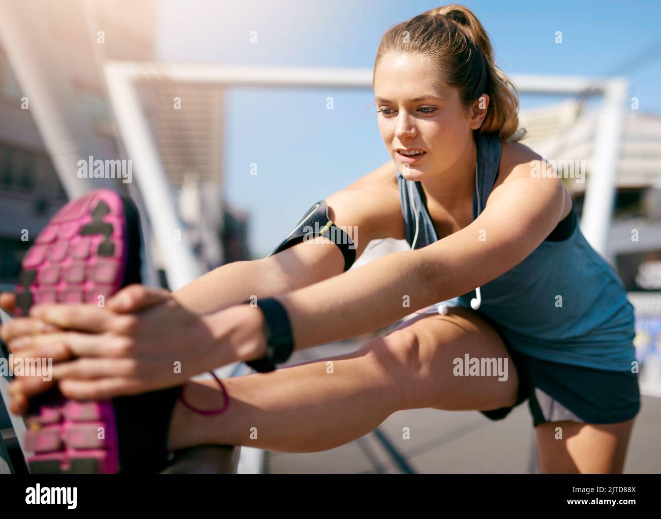 Stretch your way to a better workout. a sporty young woman stretching ...