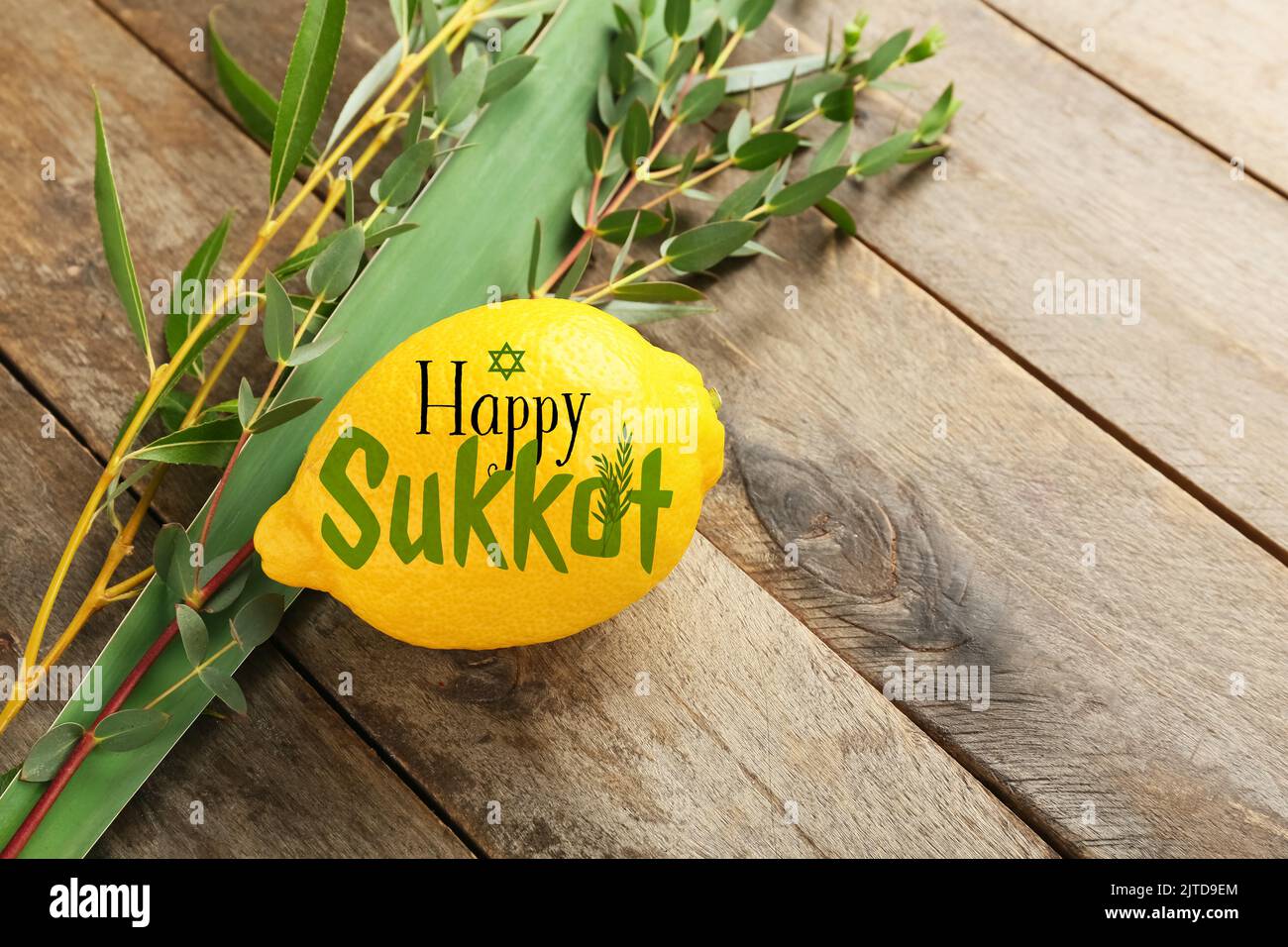 Greeting card with Sukkot festival symbols on wooden background Stock ...