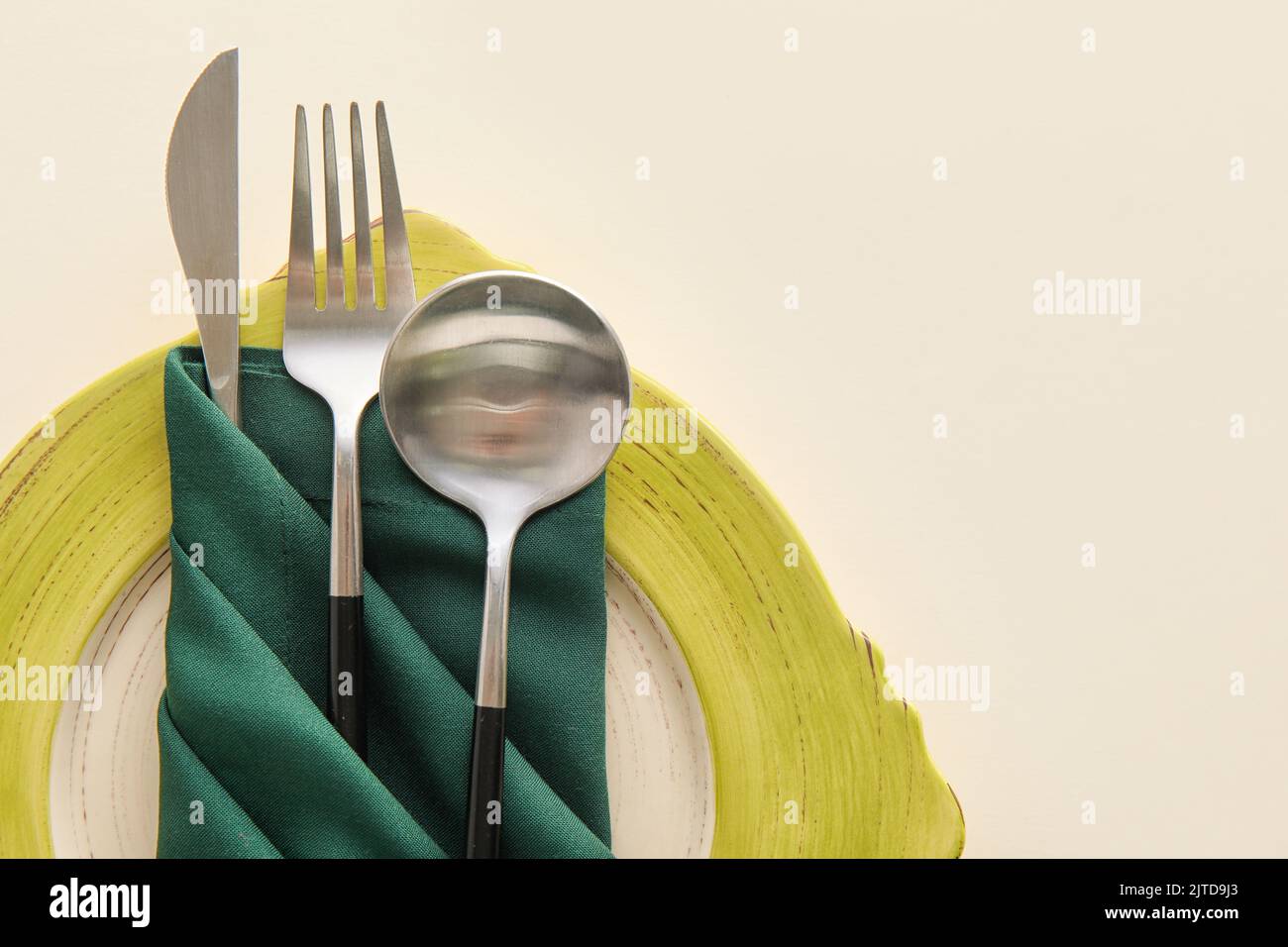 Green table setting on white background Stock Photo - Alamy