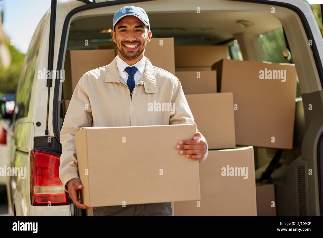 You order it, we deliver it. Portrait of a friendly delivery man ...