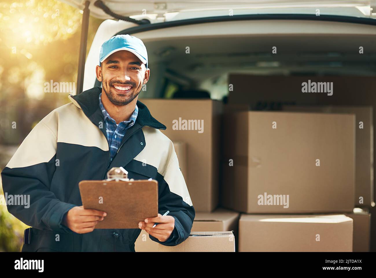 Your package will reach you shortly. Portrait of a courier checking the ...