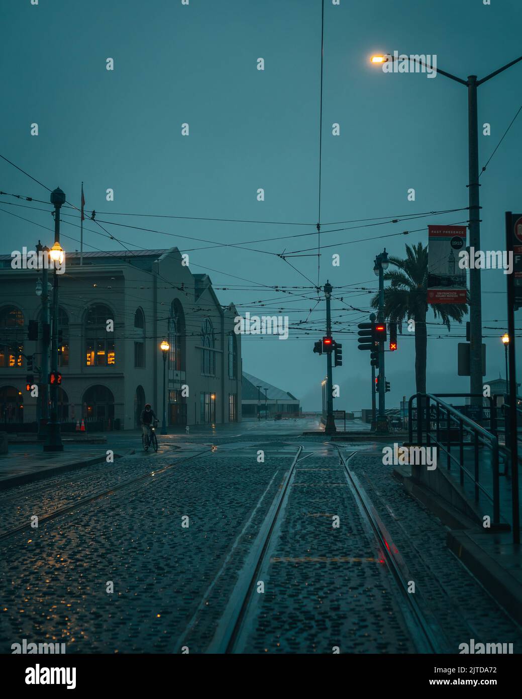 Cobblestone street and tram tracks on a rainy night at the Embarcadero ...