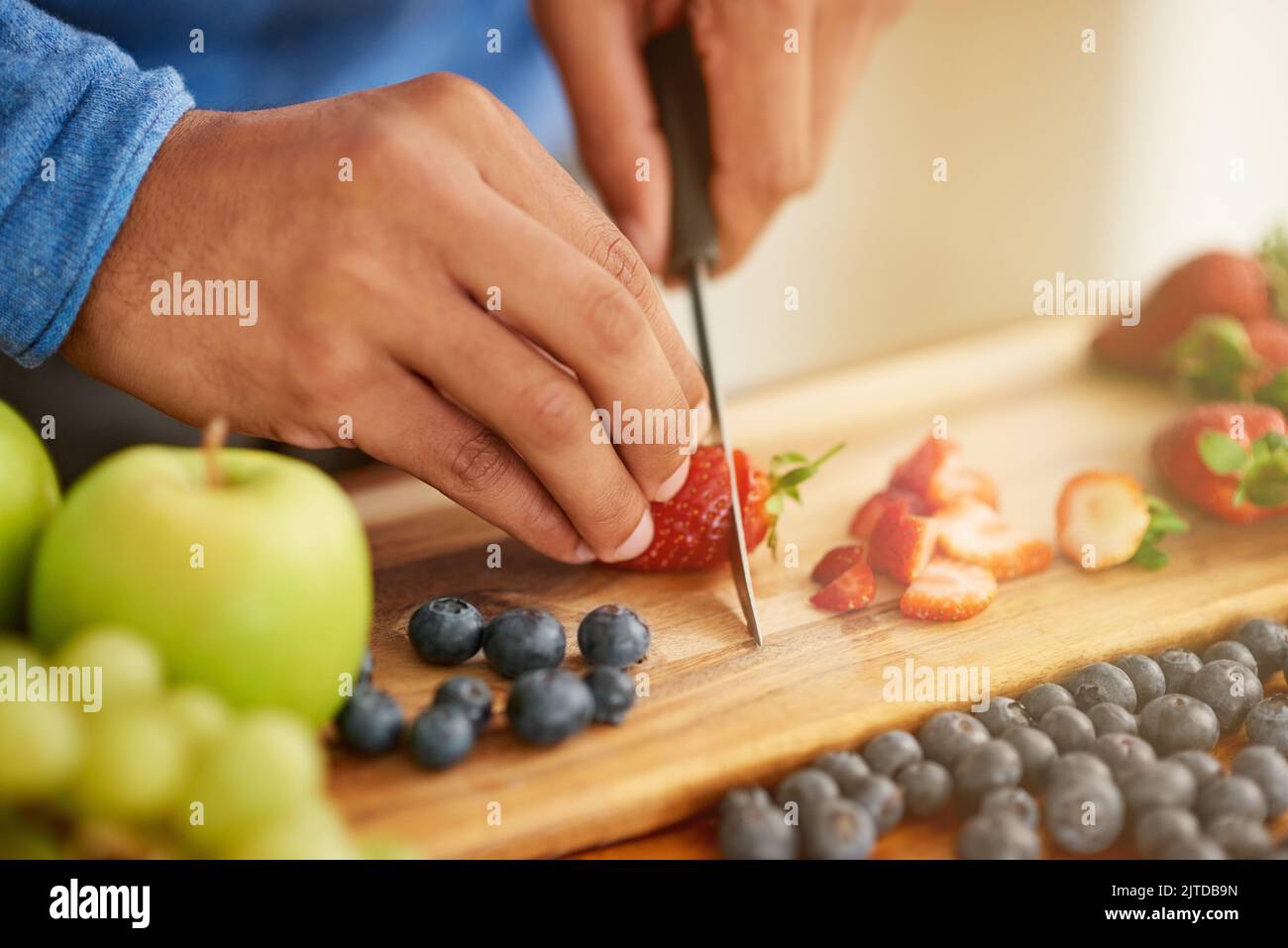 Taking a slice of the healthy life. a man preparing a healthy and ...