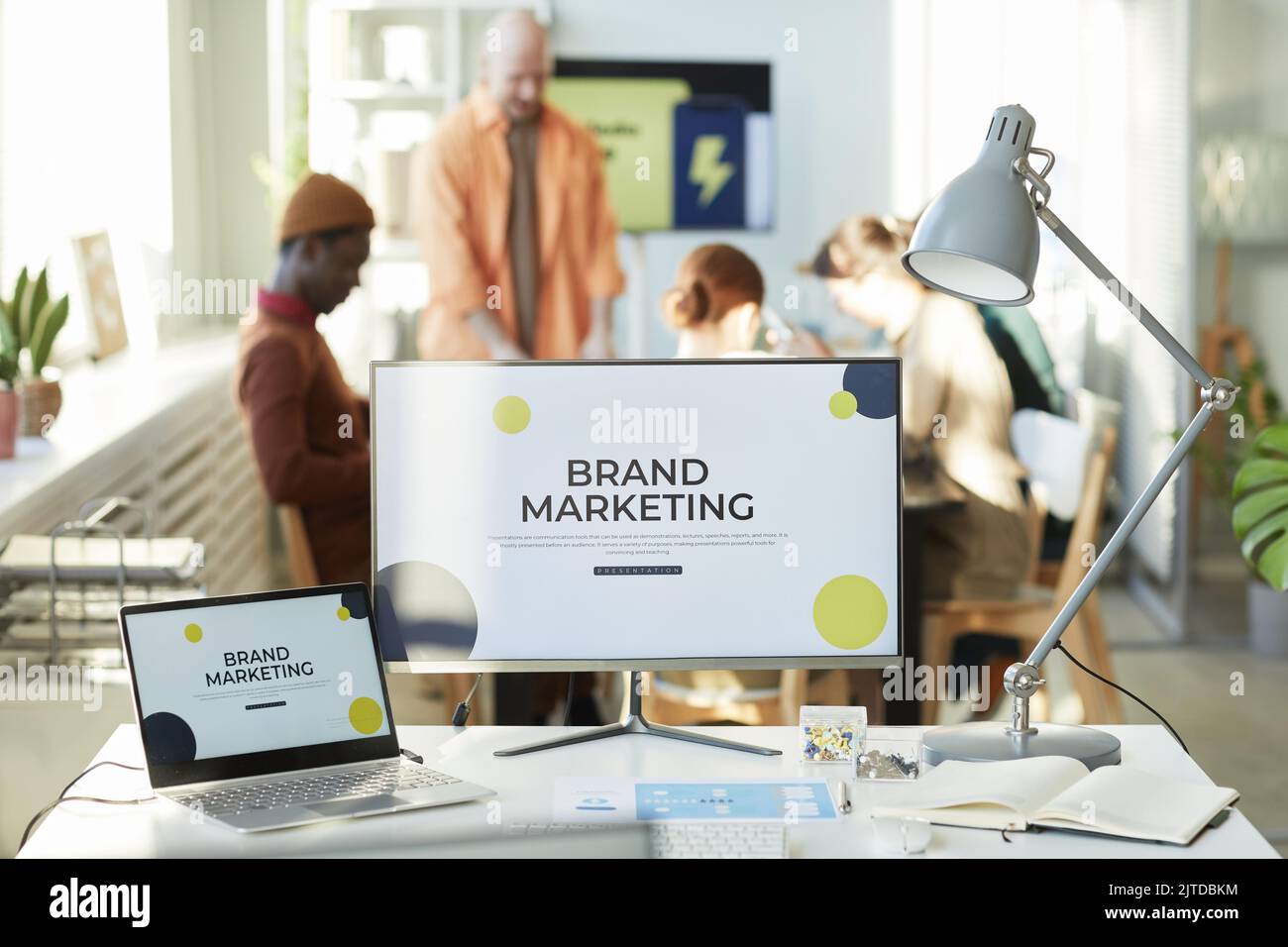 Background image of computer screen with Brand marketing slogan on desk ...