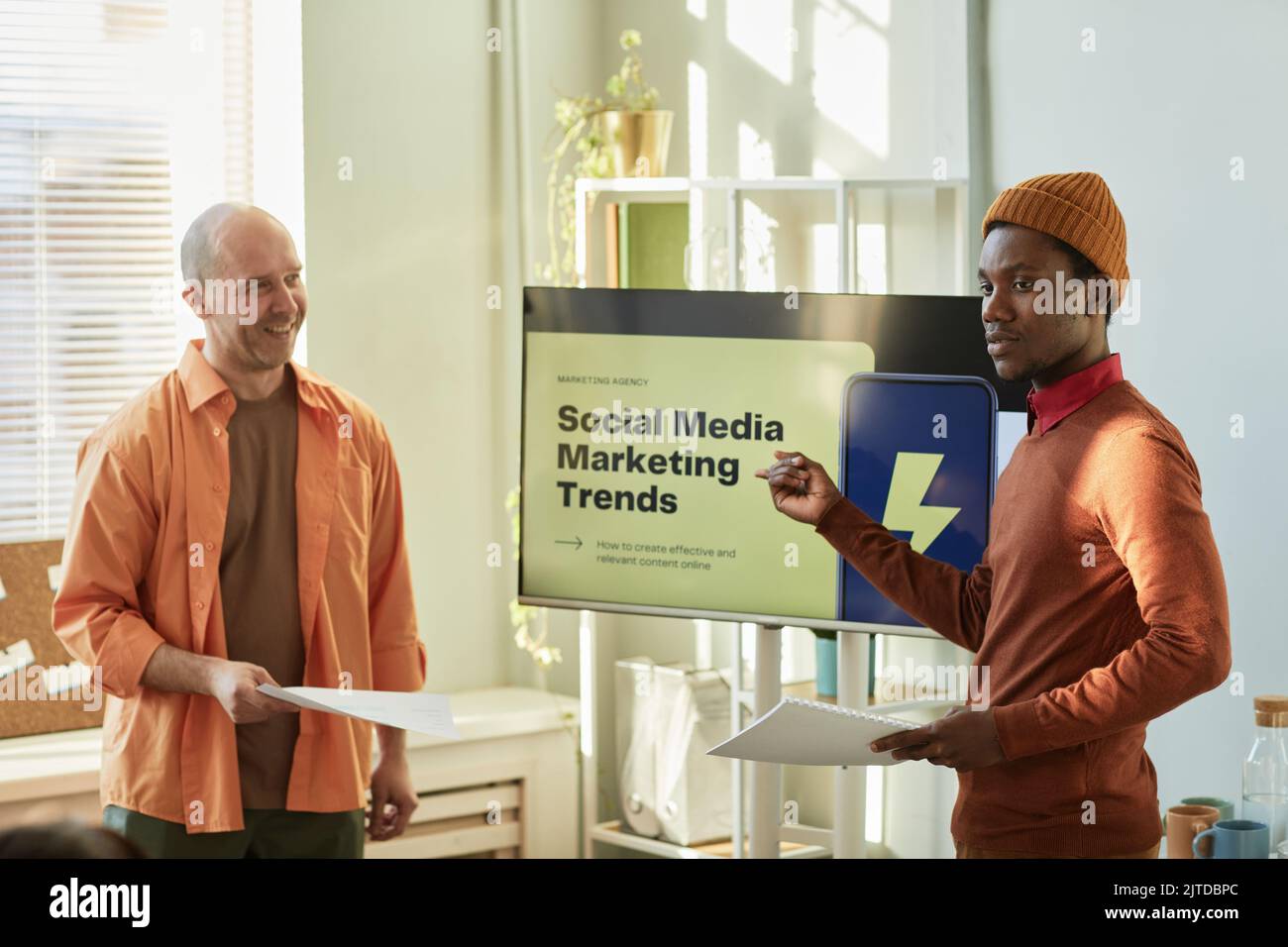 Portrait of creative black man presenting Social media marketing trends ...