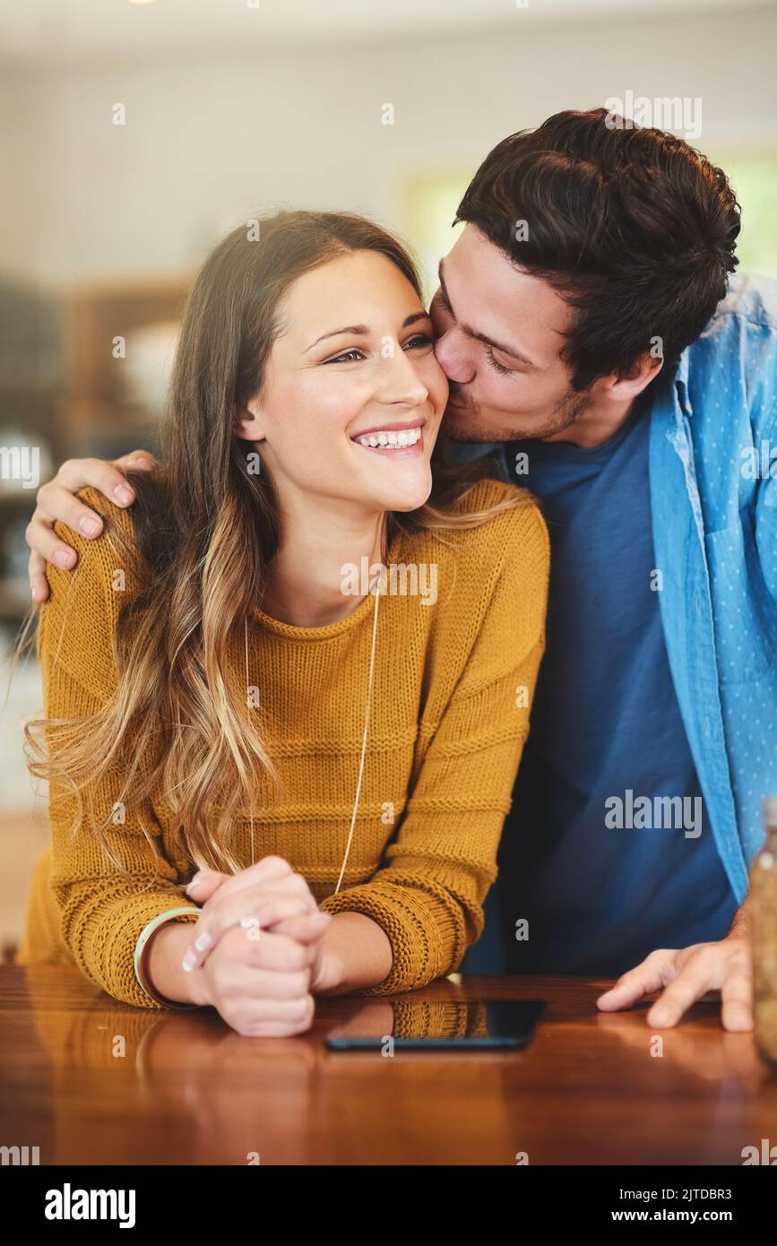 Spread The Love An Affectionate Young Man Kissing His Girlfriend On