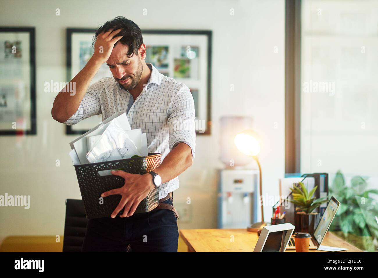 His worst fears have come true. a stressed businessman holding his box ...