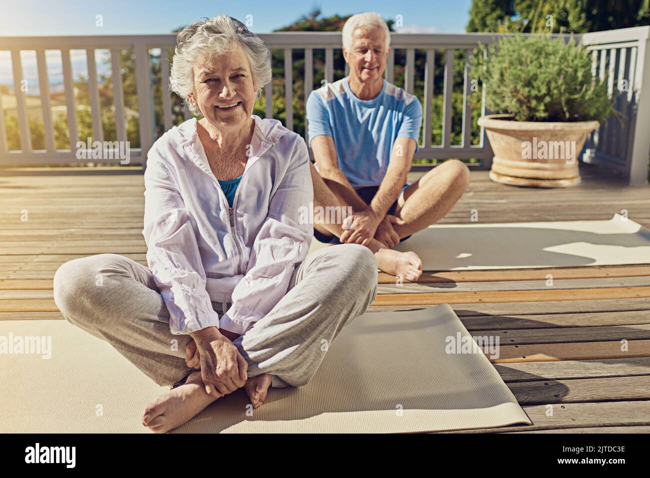 Staying fit and healthy through yoga. Portrait of a senior couple doing ...