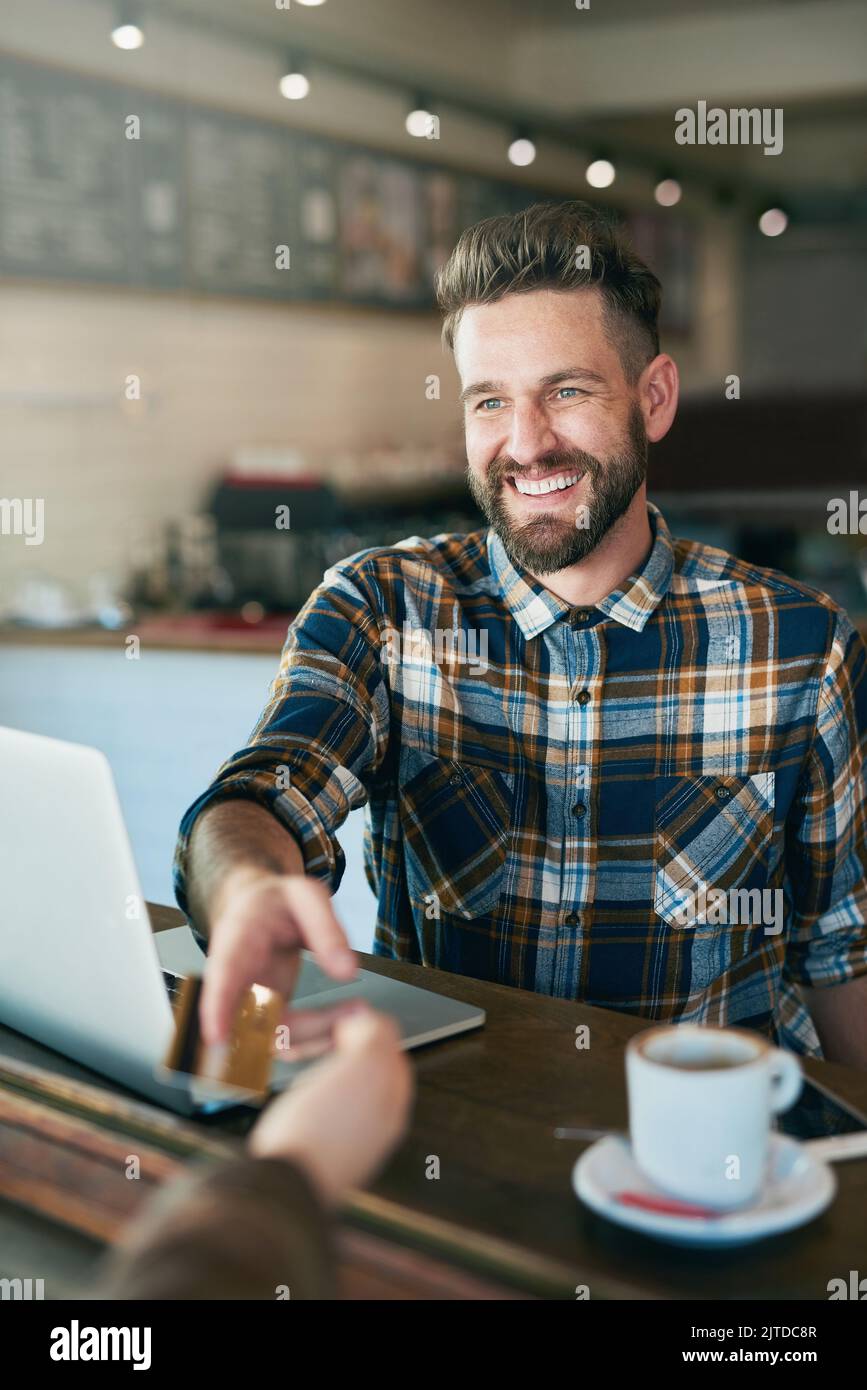 The most efficient way to pay these days. a young man paying with a ...