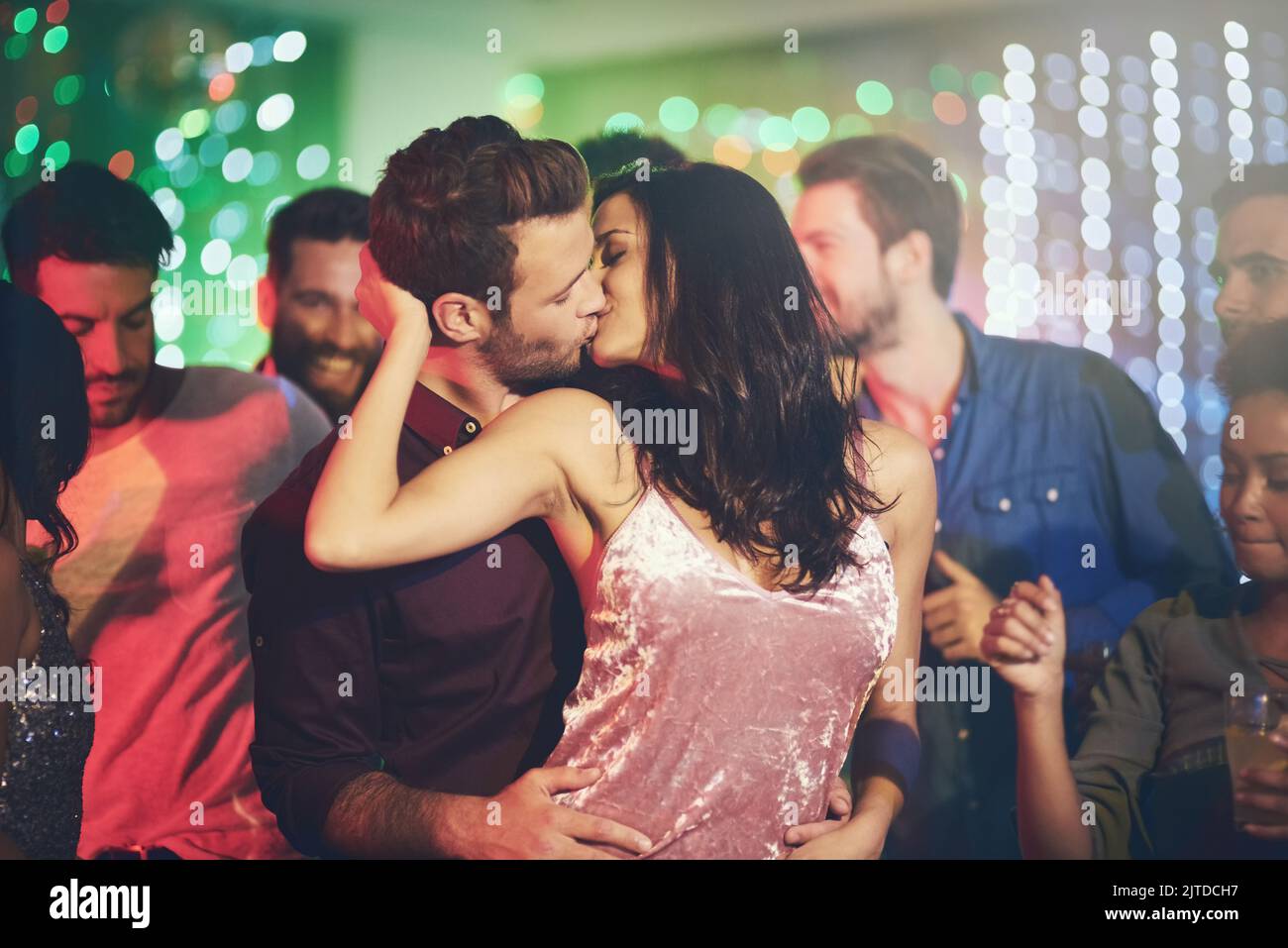 Its his lucky night. an affectionate young couple dancing on a crowded ...