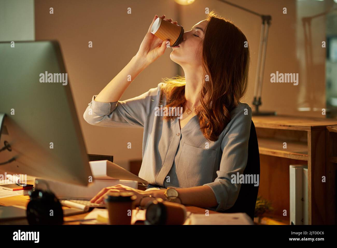 The Caffeine Keeps Her Going An Attractive Young Businesswoman