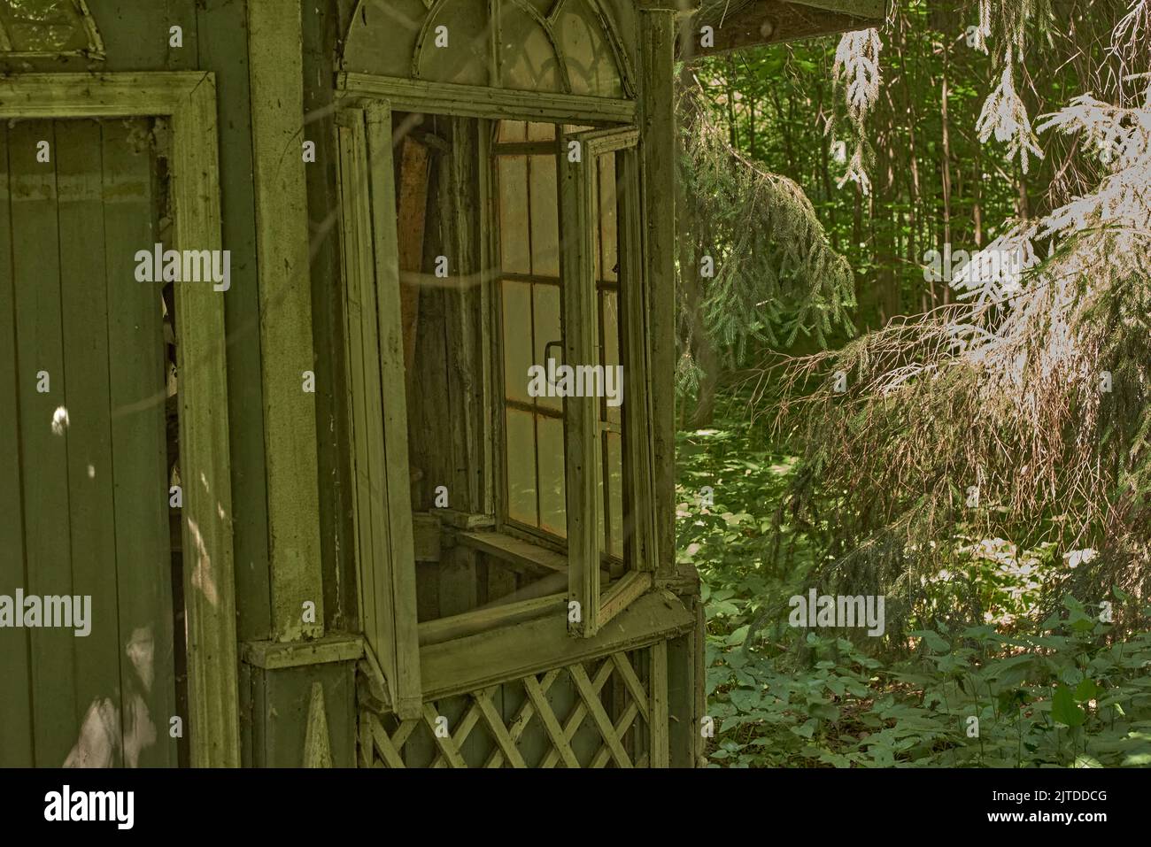 Summer cloudy day. There is an old dilapidated summer gazebo in the ...